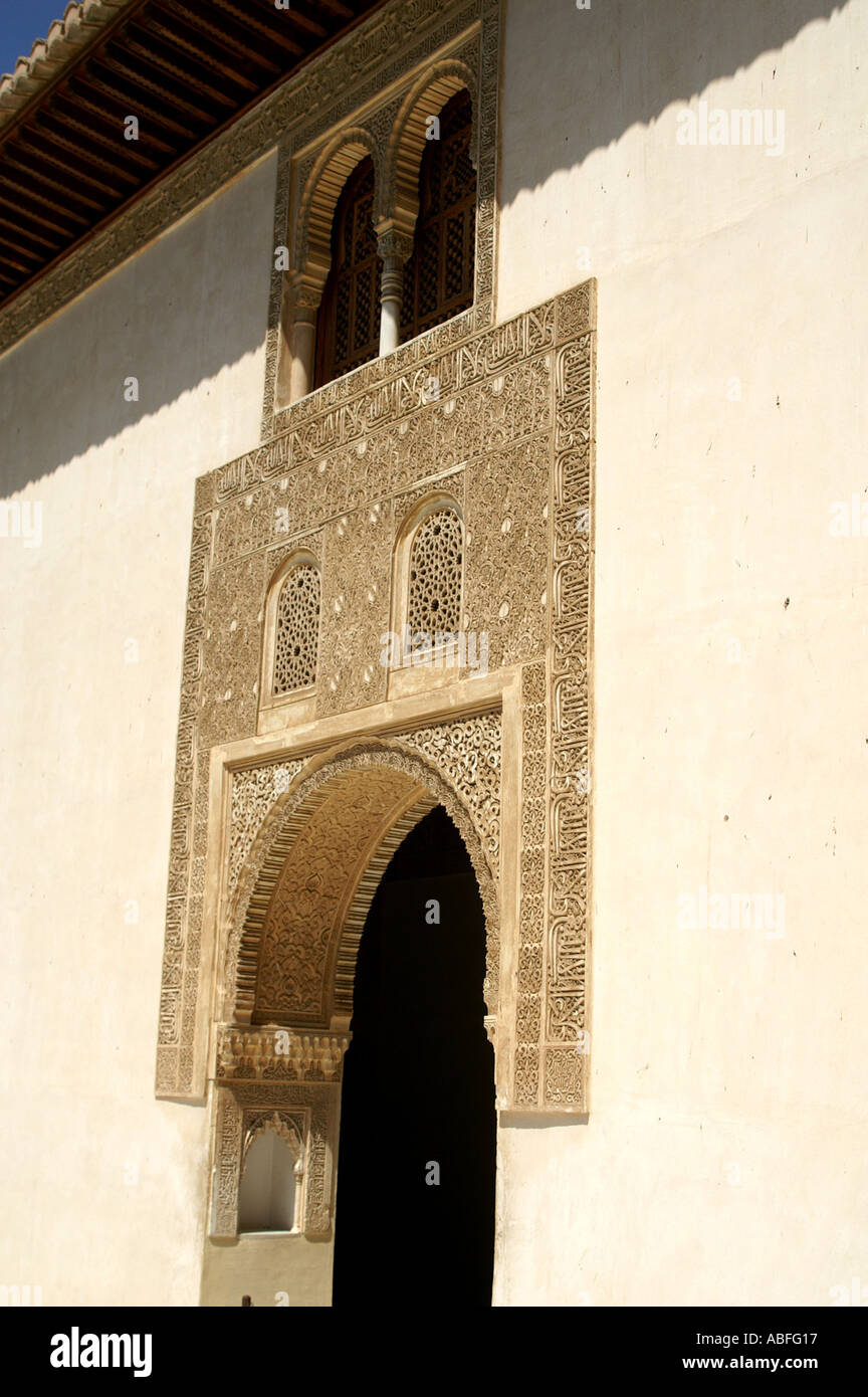 Intricate plasterwork around doorway wall and windows in moorish palace Alhambra Granada ...