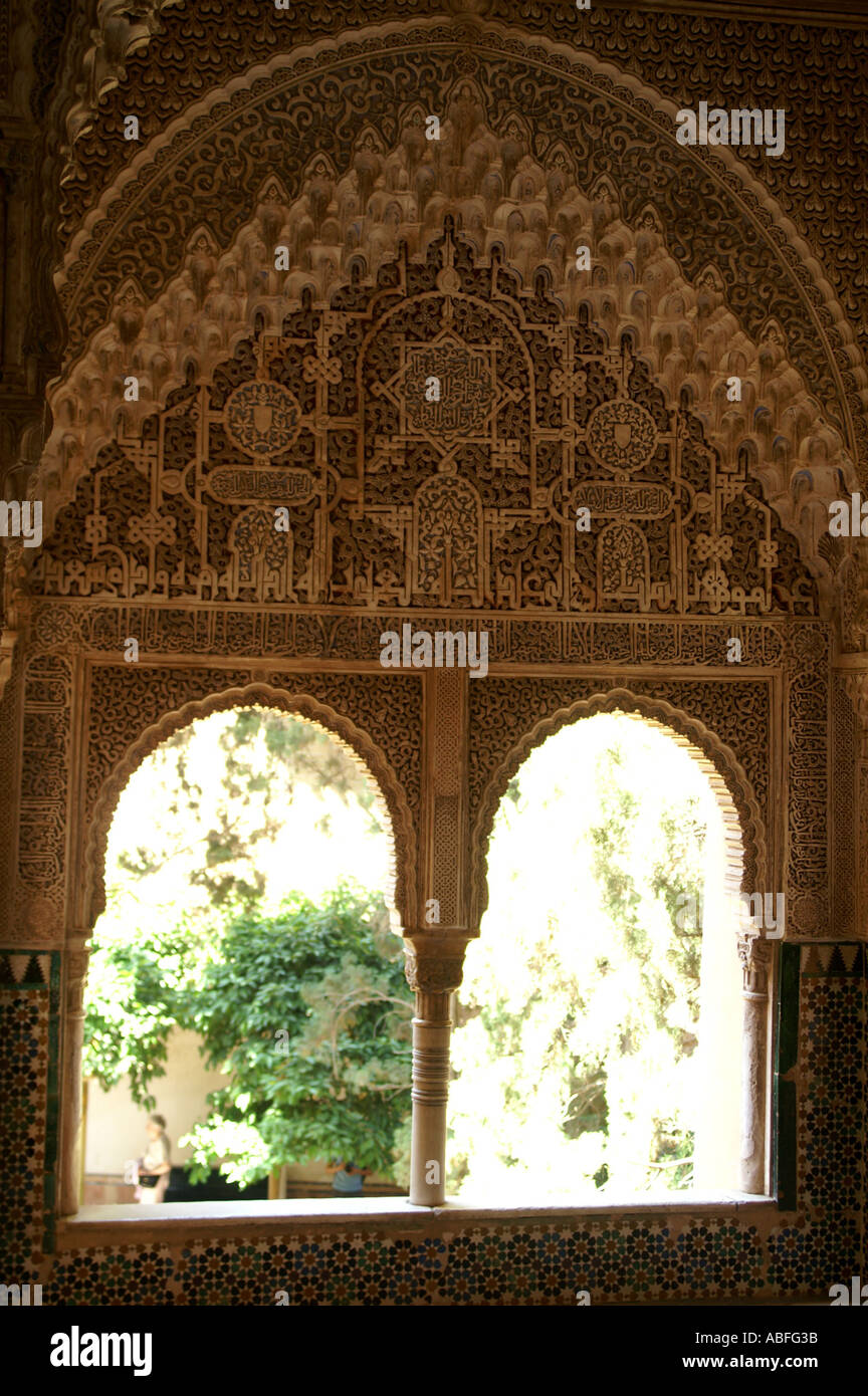 Intricate plasterwork arches wall and windows in moorish palace Alhambra Granada Andalucia Spain ...