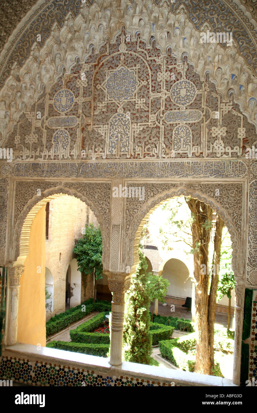 Intricate plasterwork arches wall and windows in moorish palace Alhambra Granada Andalucia Spain ...