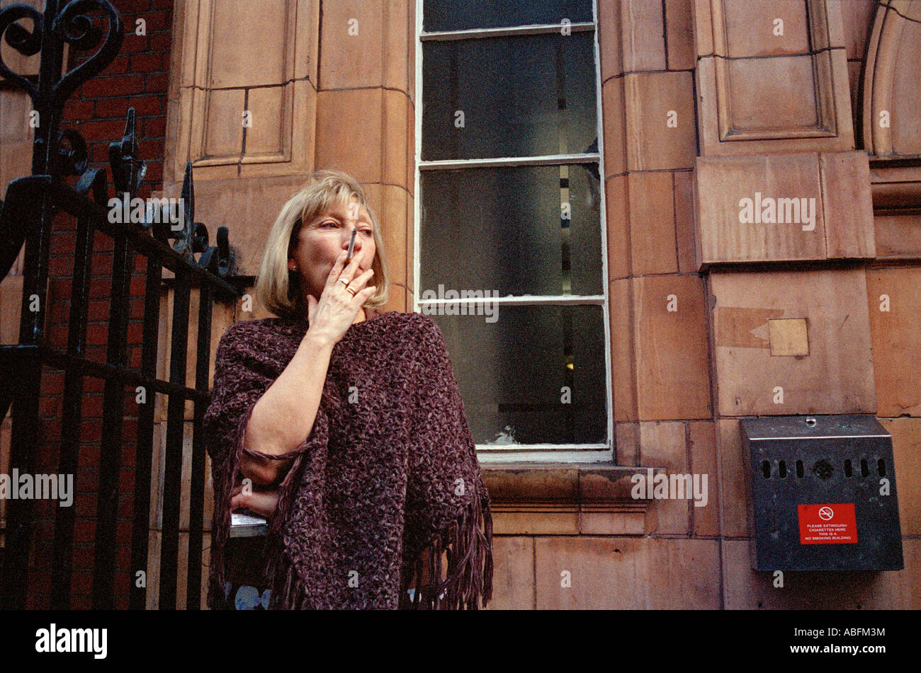 Woman smoking outside office hi-res stock photography and images - Alamy