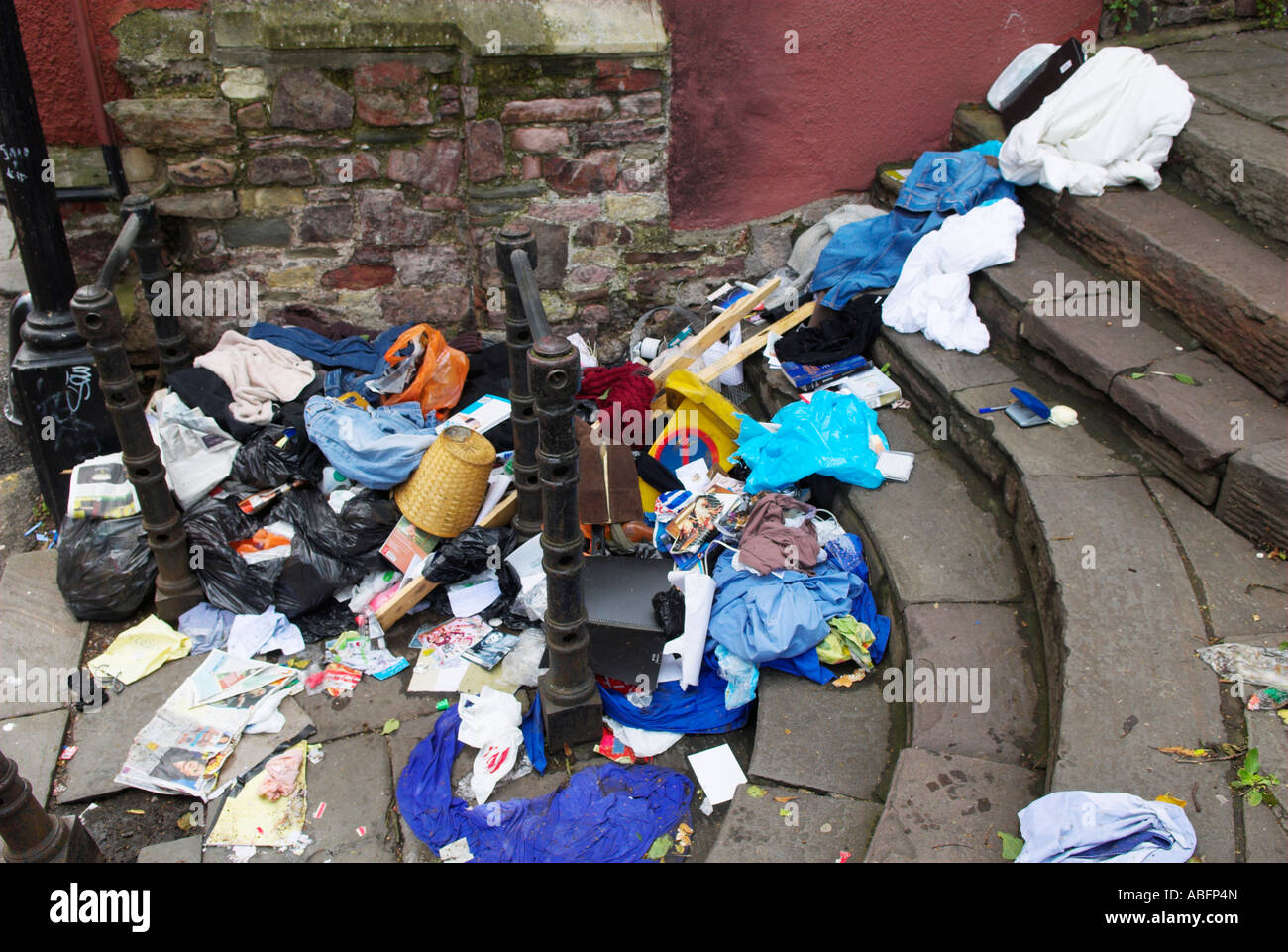 Flytiped and ripped open black plastic bin bags of rubbish on pavement ...