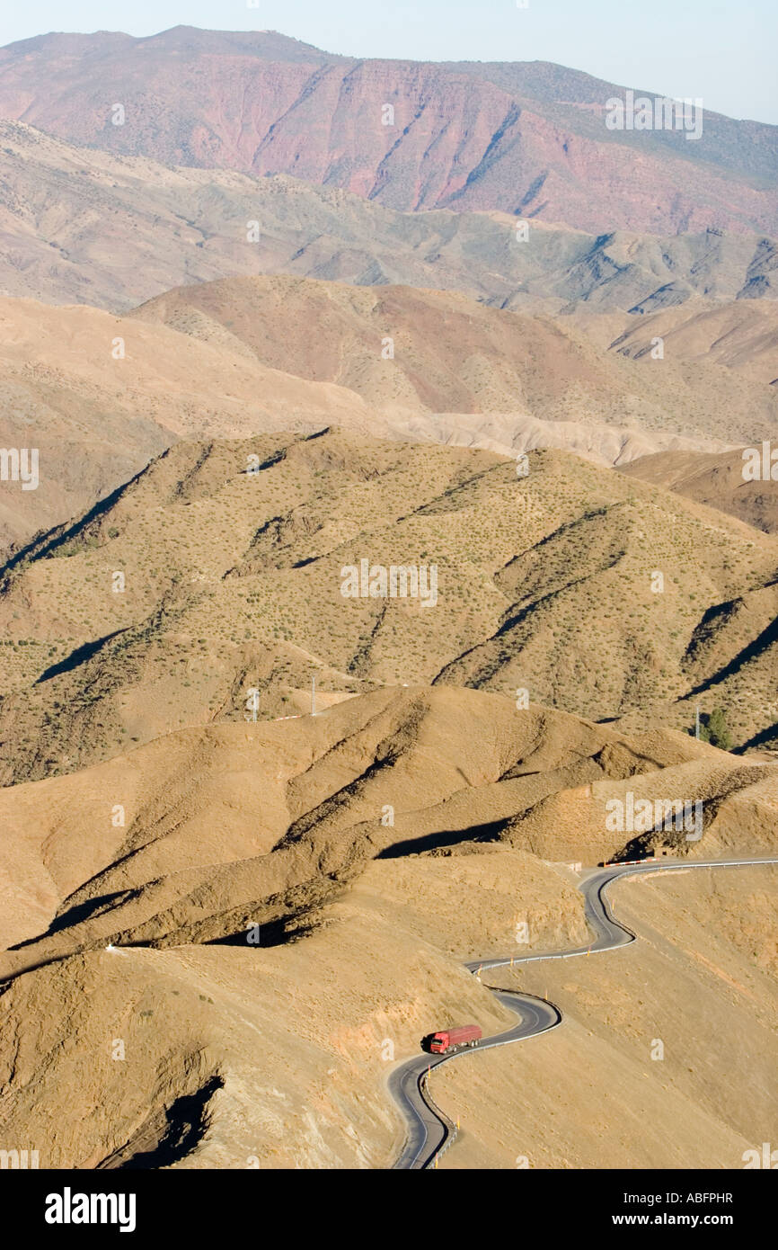 Red truck crawls up Tizi n Tichka Pass High Atlas mountains Morocco ...
