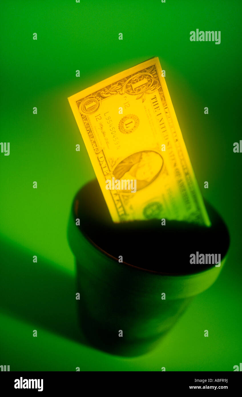 DOLLAR BANK NOTE IN PLANT POT CLAY Stock Photo - Alamy