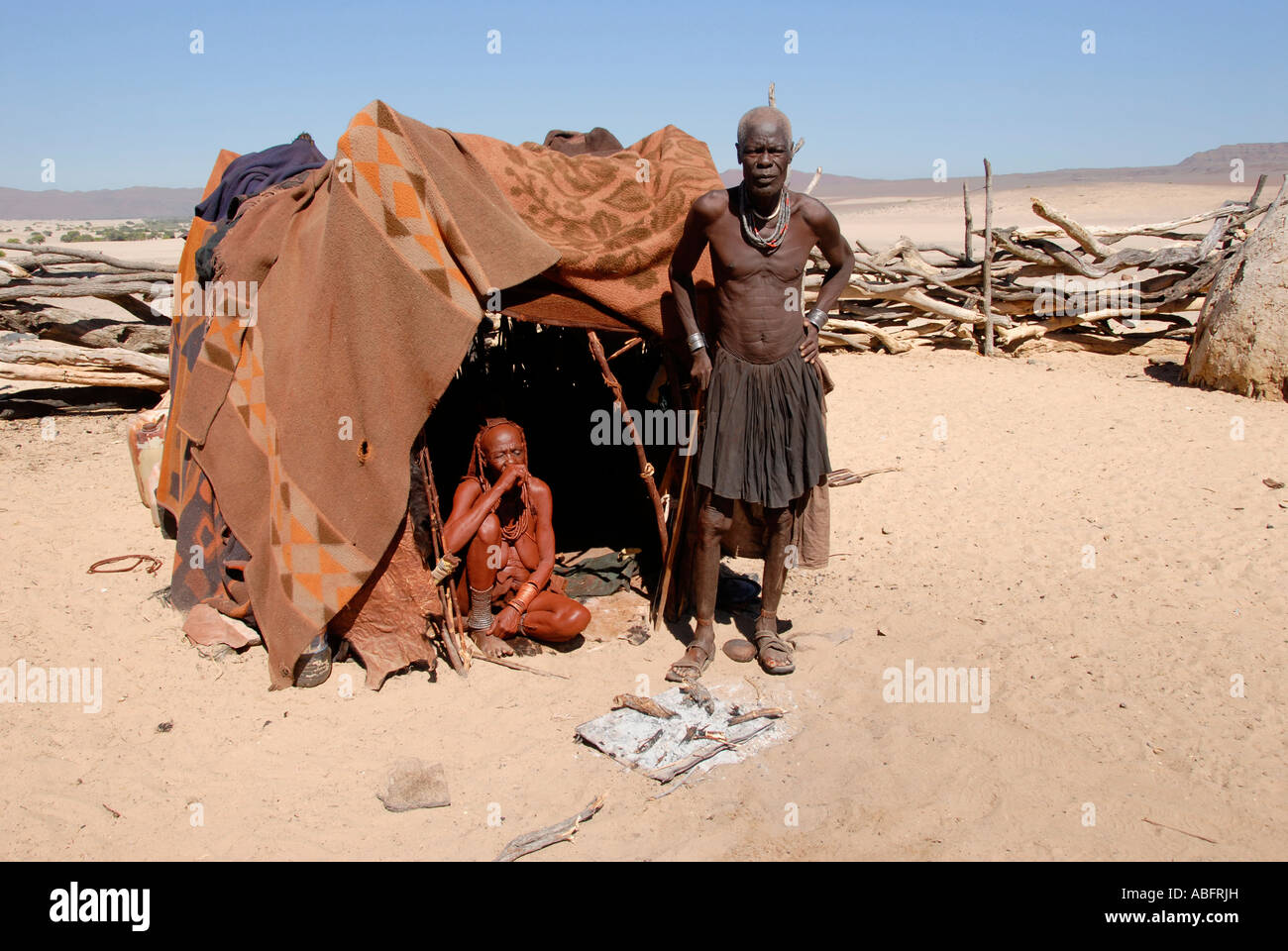 Old Himba man and woman outside hut Kaokoveld Namibia Southern Africa ...