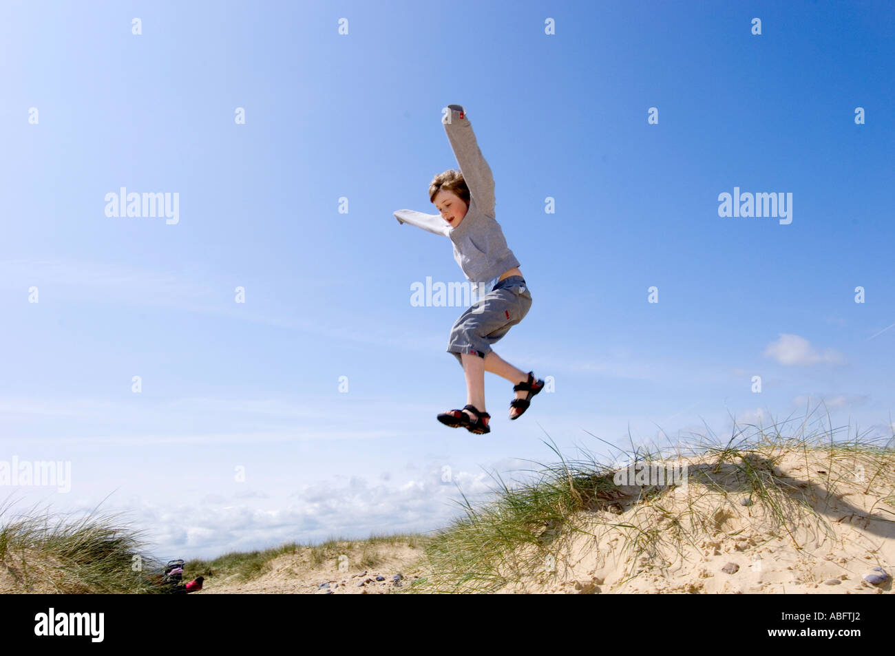 Young Child Jumping Sand Dunes Stock Photo - Alamy