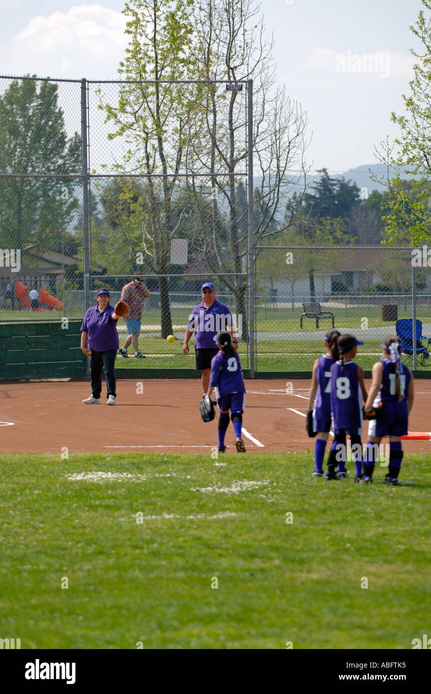 Young girls playing softball game Stock Photo - Alamy