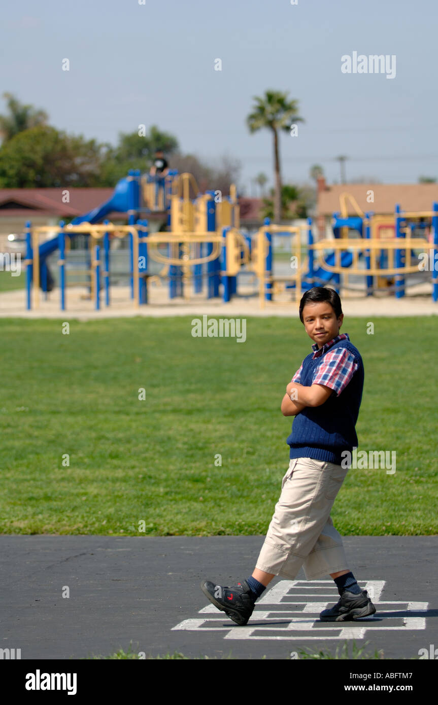 9 year old boy playing a game of hopscotch in school yard Stock Photo ...