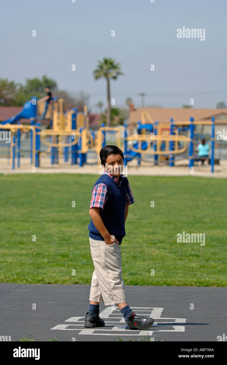 9 year old boy playing a game of hopscotch in school yard Stock Photo ...