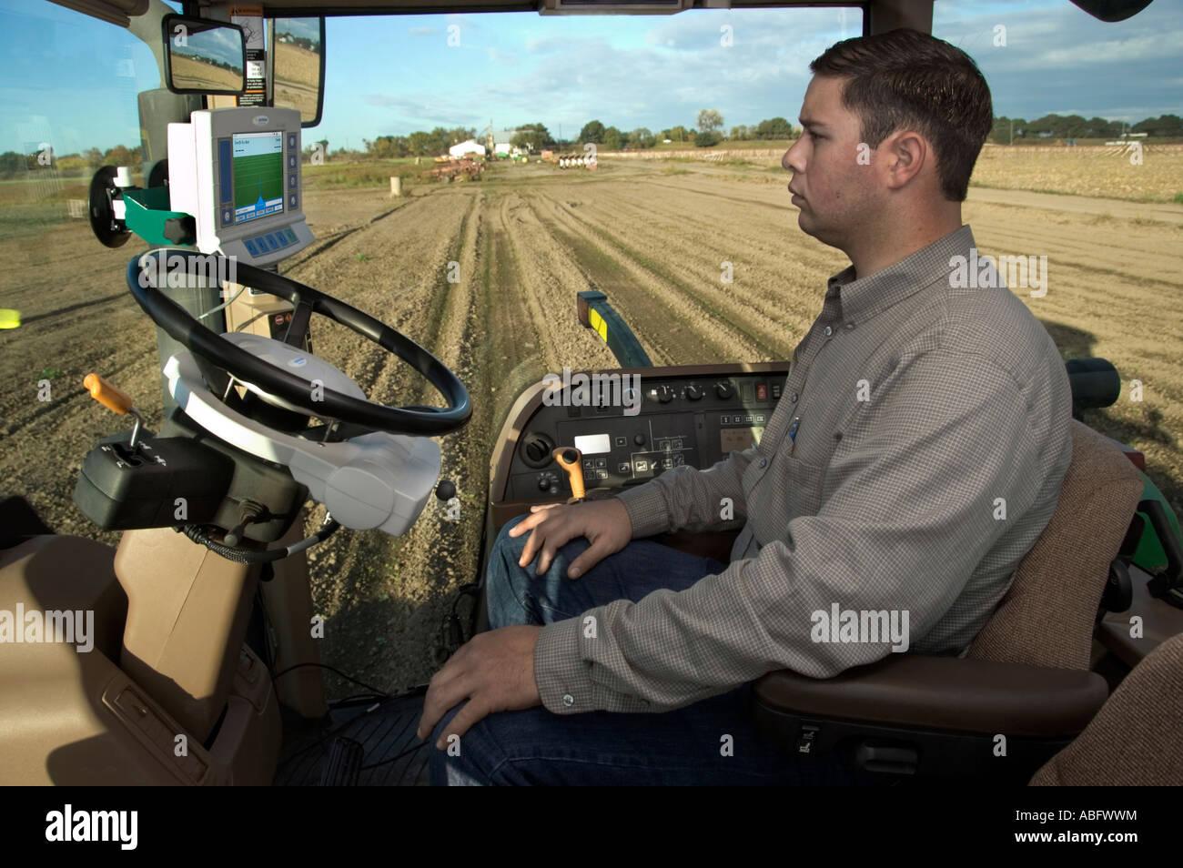 A tractor driver with GPS navigation for accurate field grading Stock ...