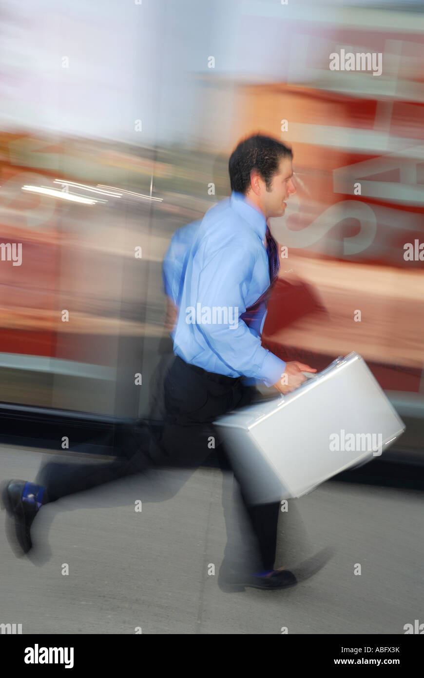 Blurred image of businessman running past a storefront window with ...