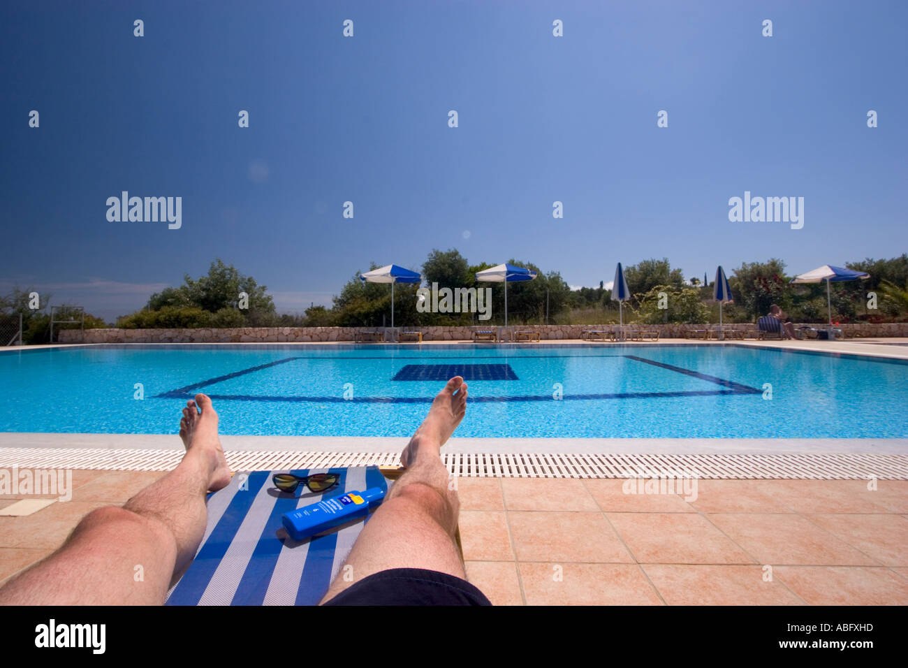 Sunbathers view of swimming pool Stock Photo - Alamy