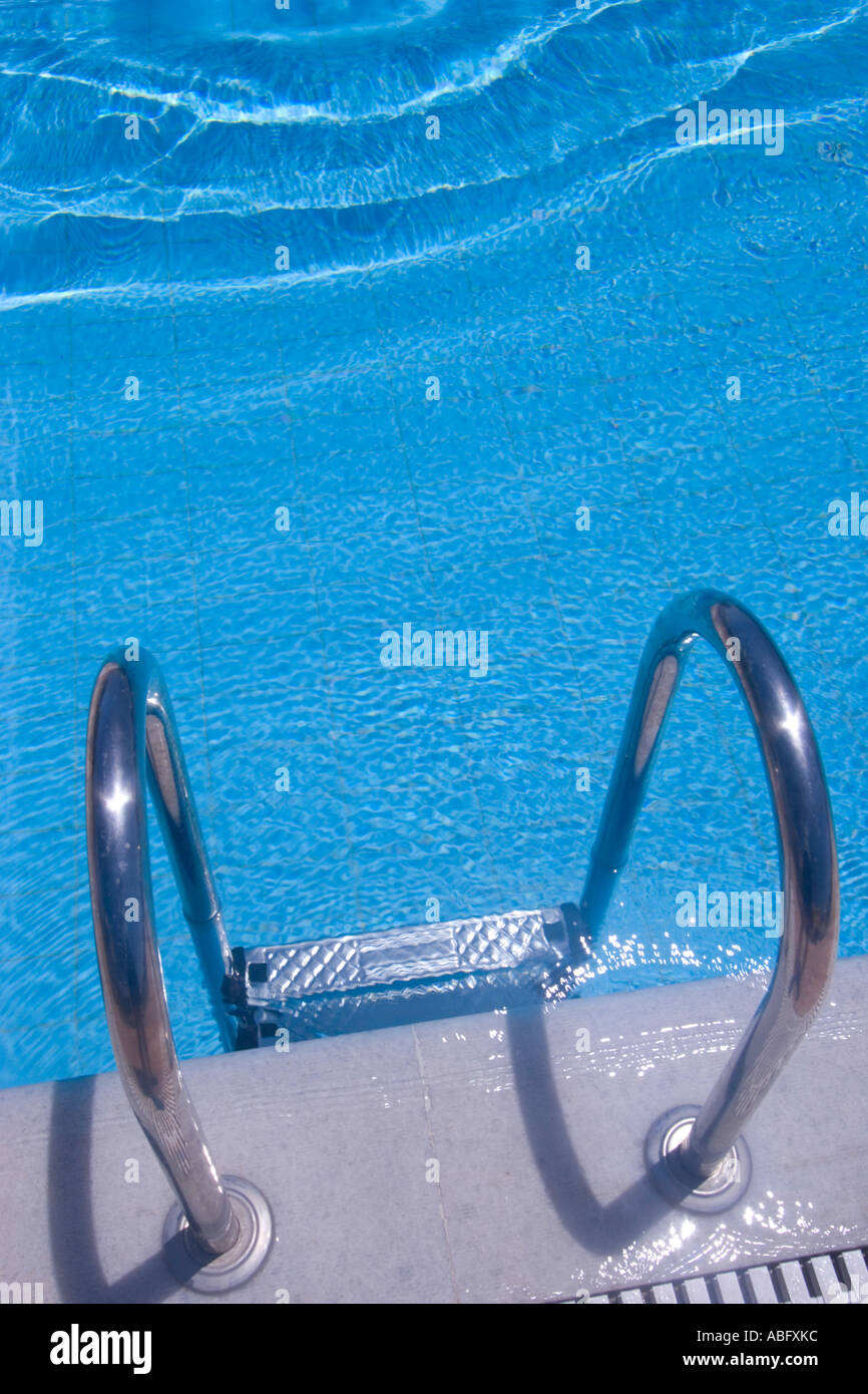 swimming pool with ripples and pool steps ladder Stock Photo - Alamy