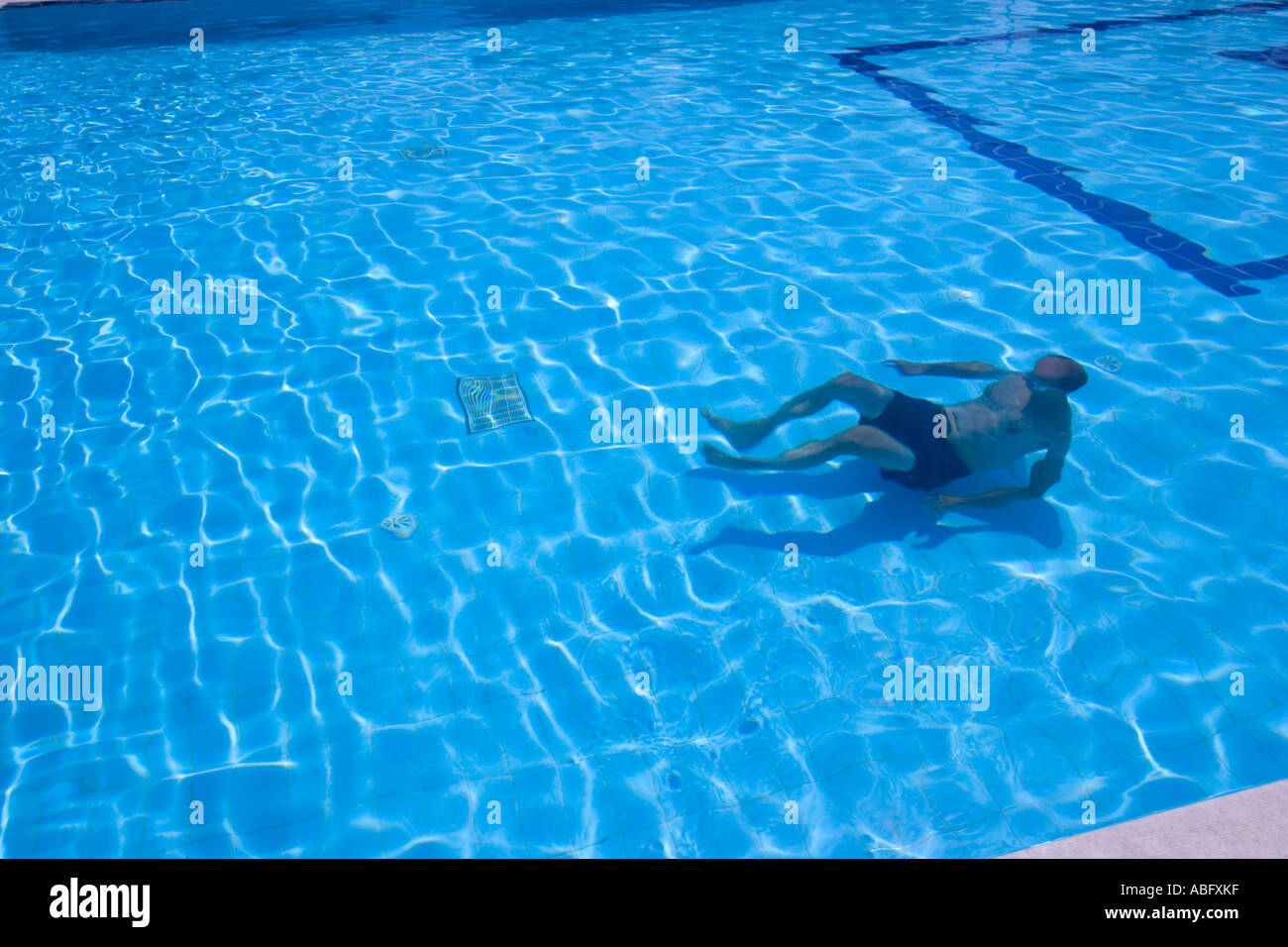 Man submerged in swimming pool Stock Photo - Alamy