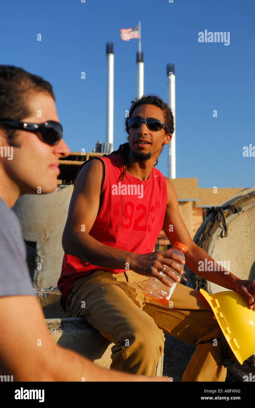 White and black construction workers resting on a job break in Bend ...