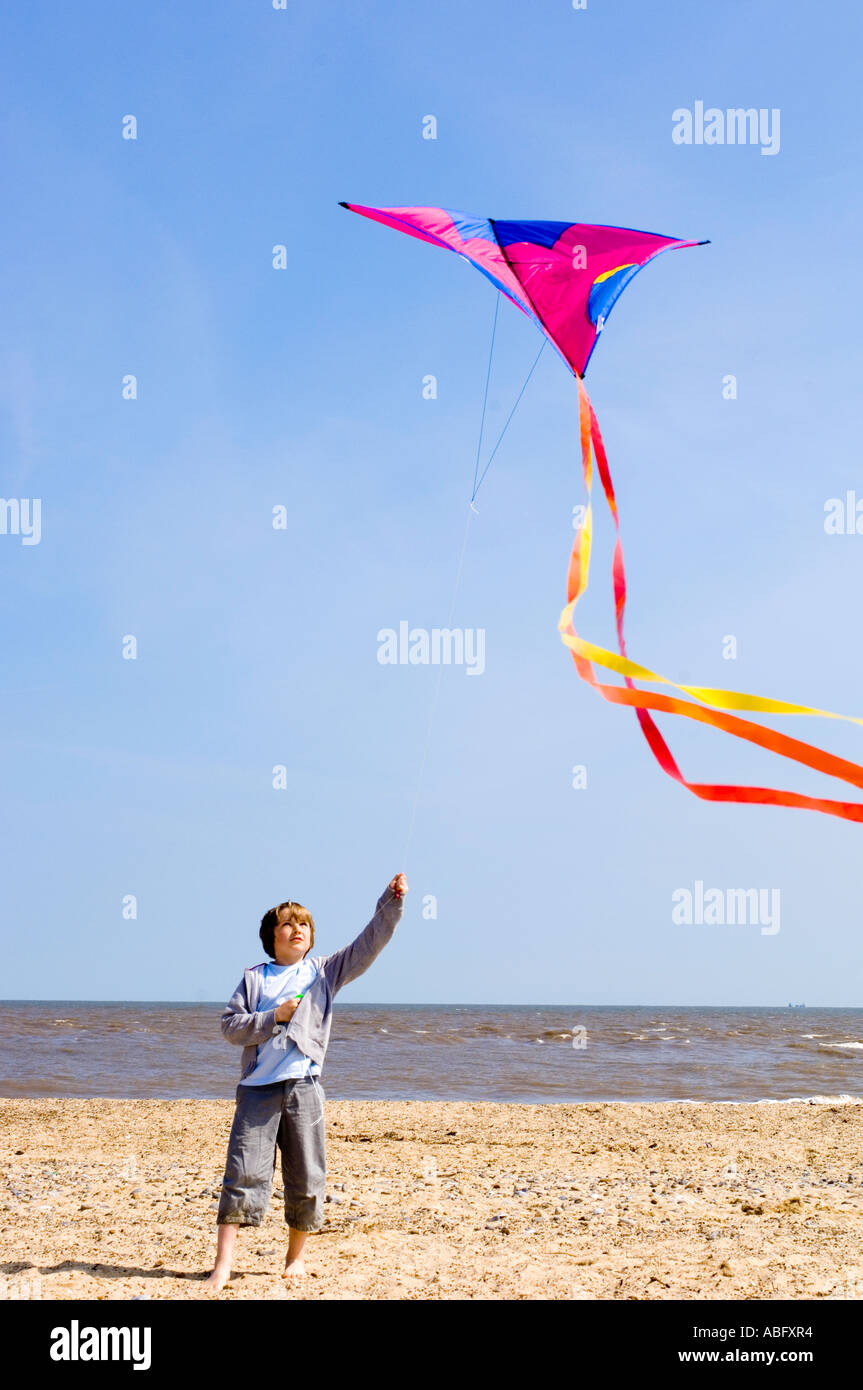 Young Child Playing With Kite on The Beach Stock Photo - Alamy
