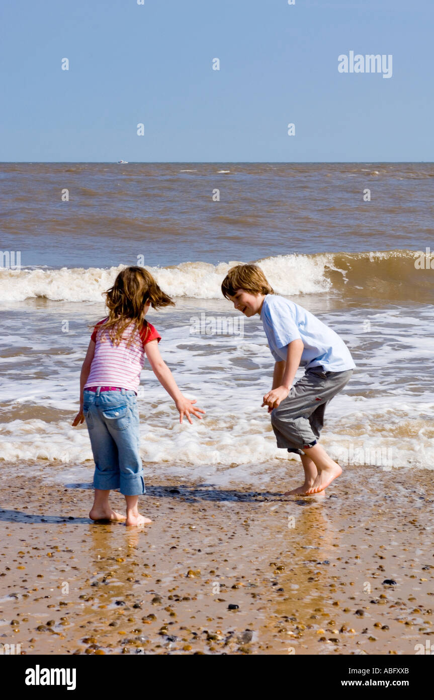 Girl running from waves hi-res stock photography and images - Alamy