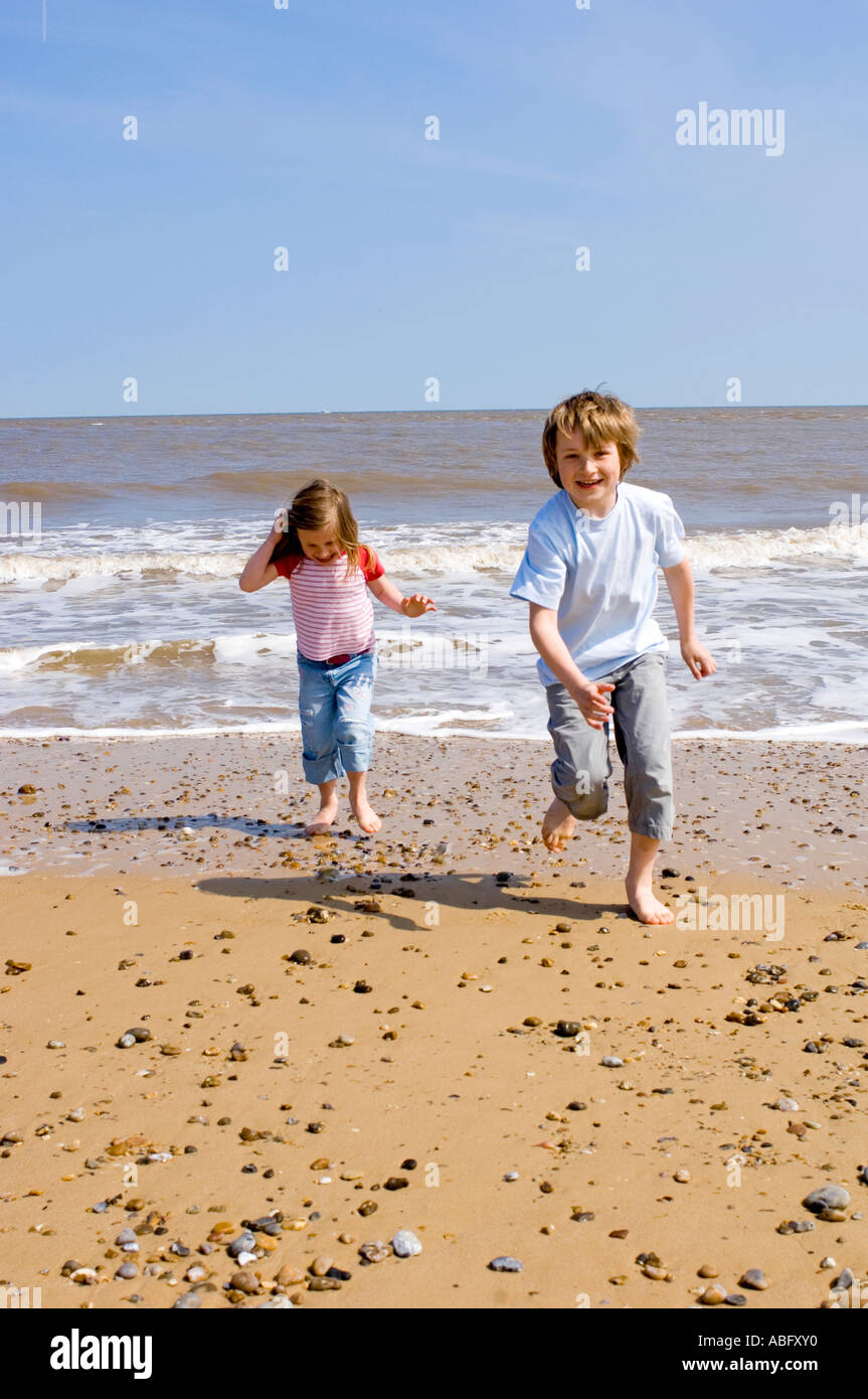 Girl running from waves hi-res stock photography and images - Alamy