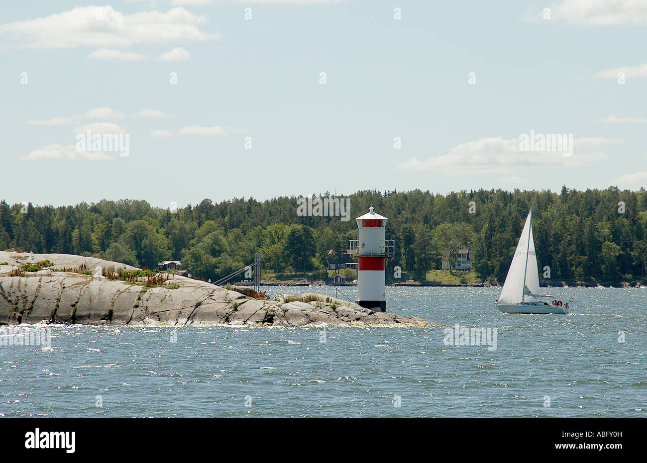 Sailboat and lighthouse Stock Photo - Alamy