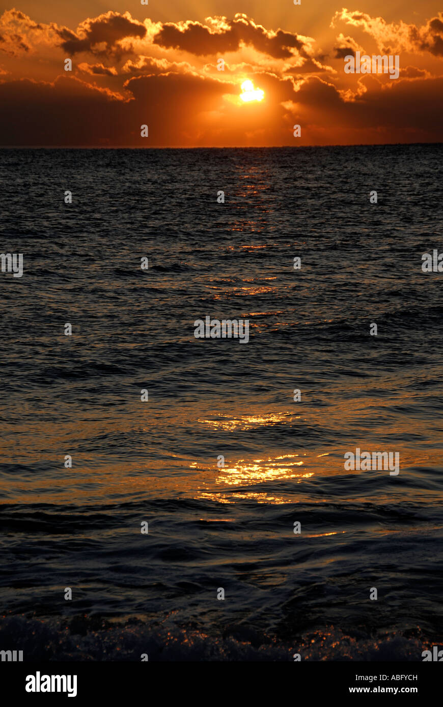 Dramatic sunset over water Stock Photo - Alamy