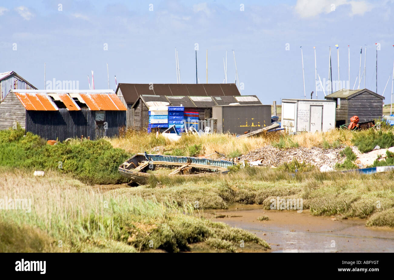 Boatyard with corregated building and sailing boats at Brancaster ...