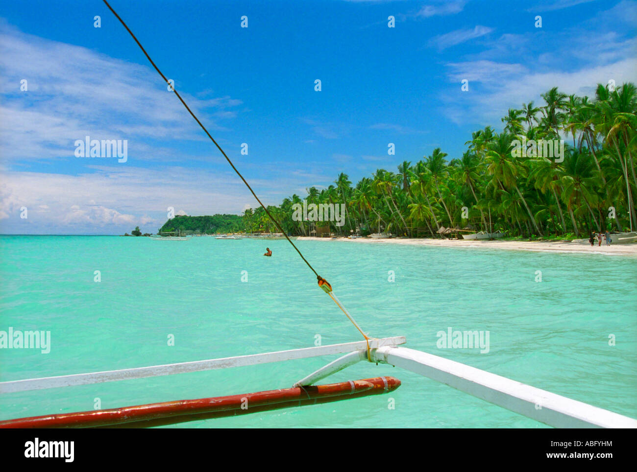 Boracay beach in the Philippines being approached by local fishing boat ...