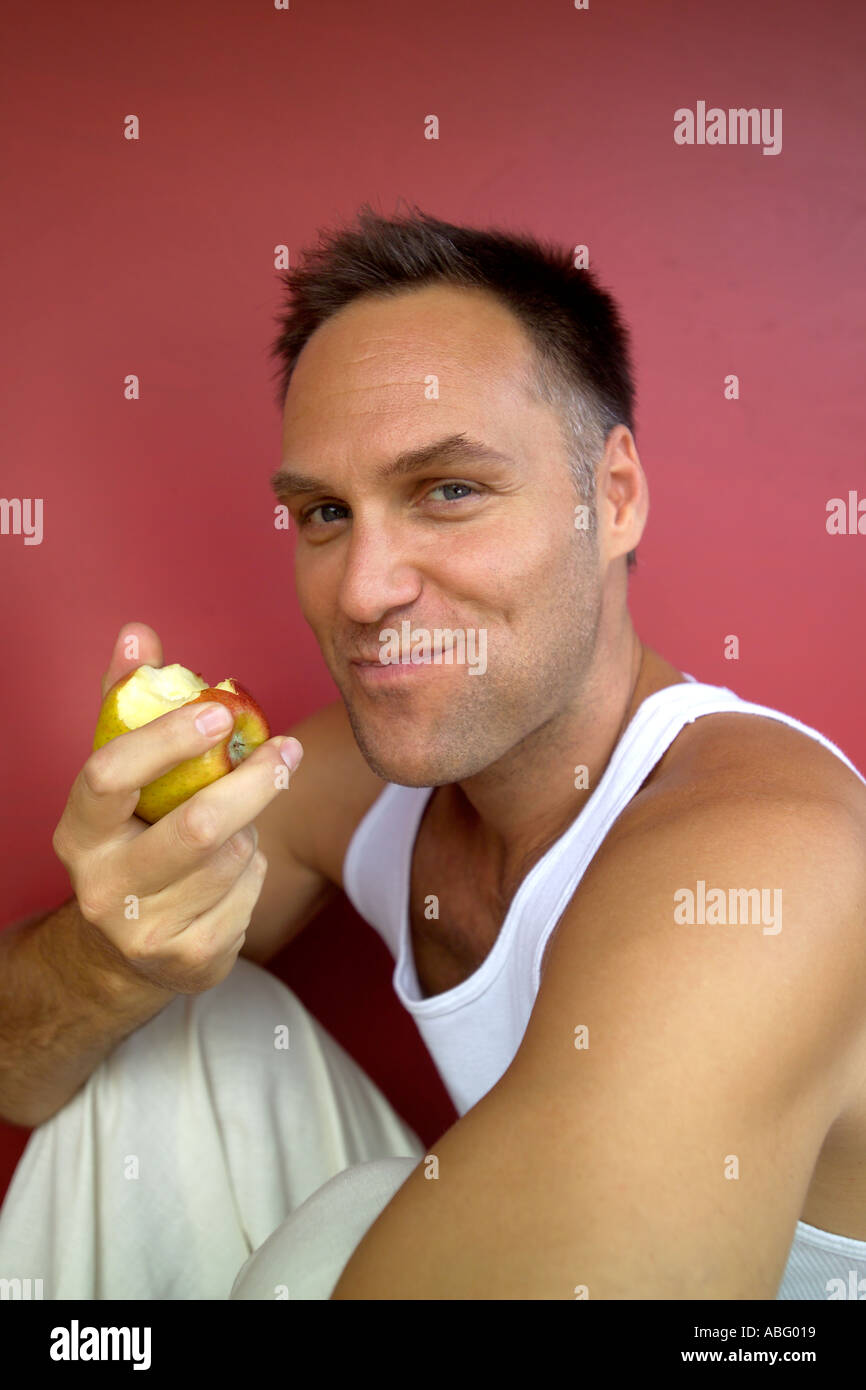 portrait of man eating an apple Stock Photo - Alamy