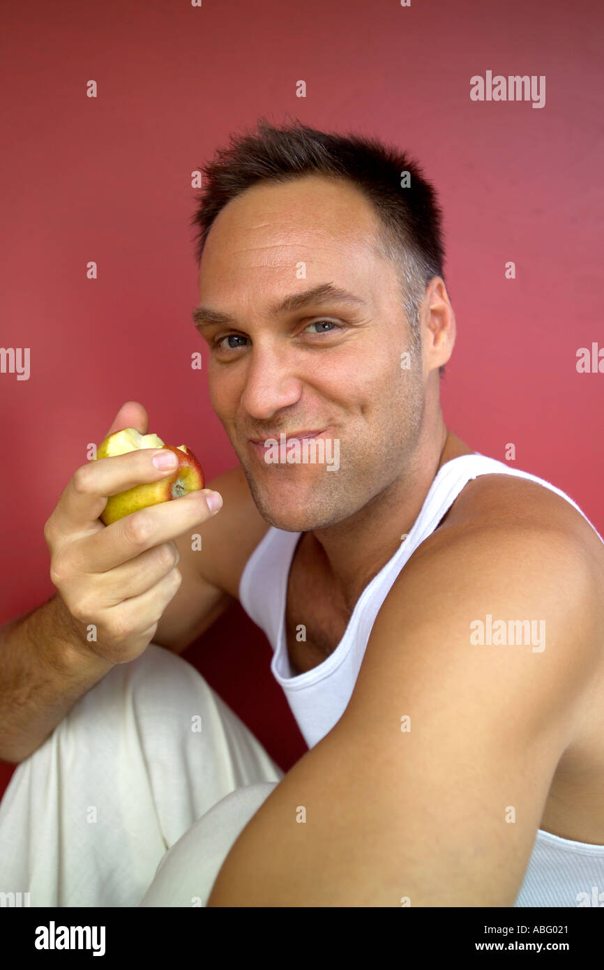 portrait of man eating an apple Stock Photo - Alamy