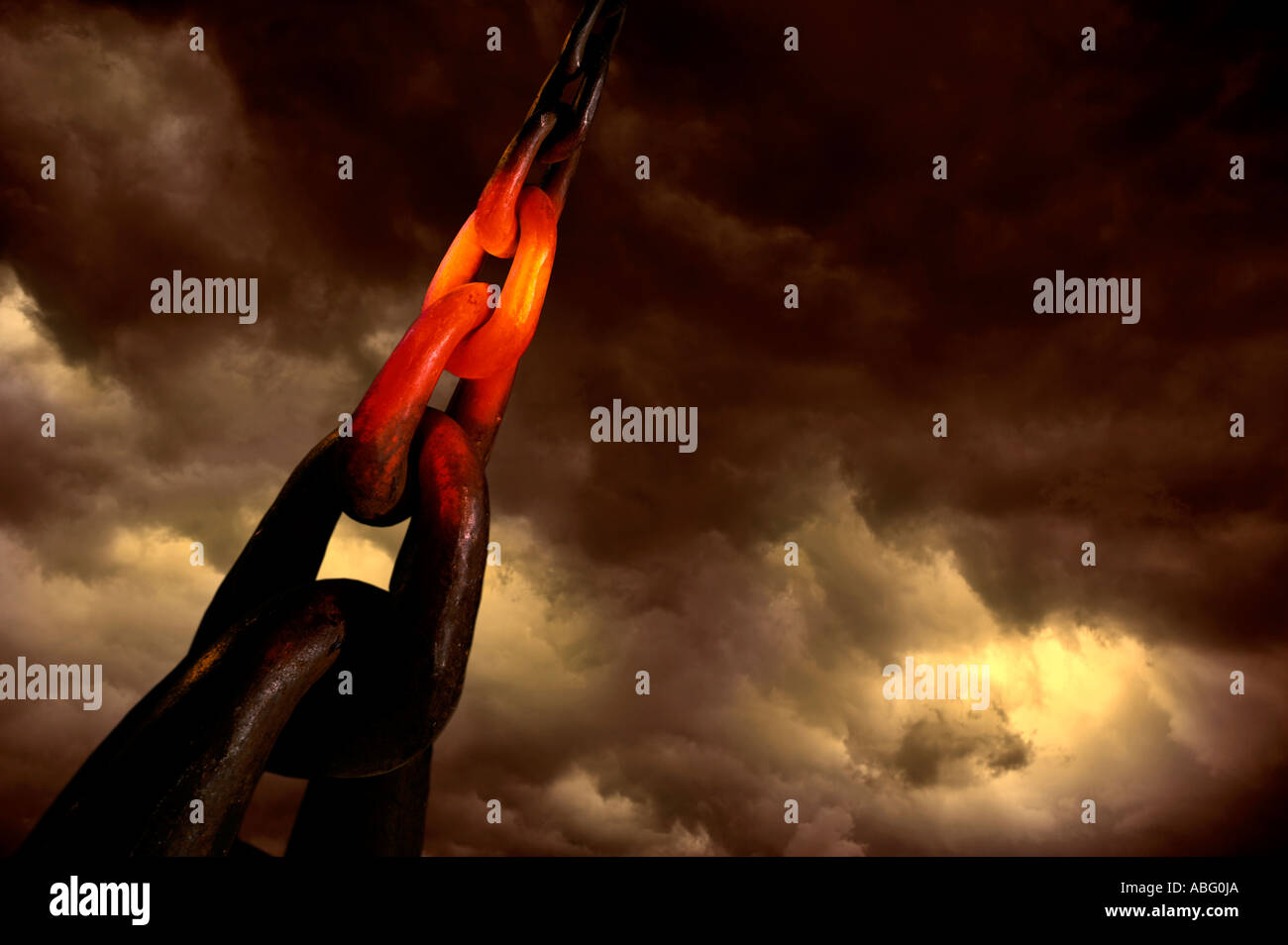 HEAVY STEEL CHAIN WITH GLOWING RED LINKS HANGING FROM STORM CLOUDS IN ...