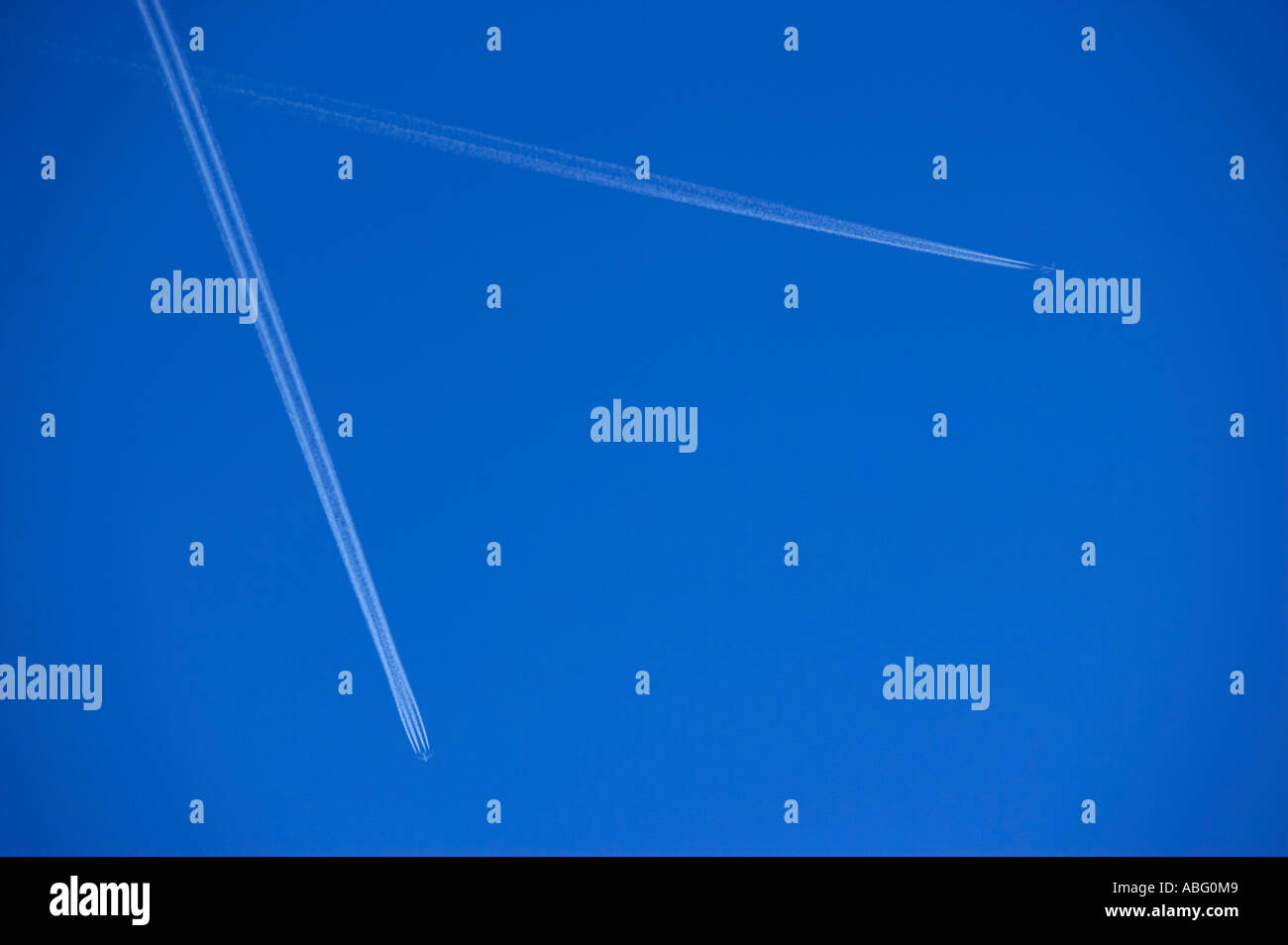 TWO JET AIRCRAFT WITH EXHAUST VAPOUR TRAILS IN CLEAR BLUE SKY Stock ...