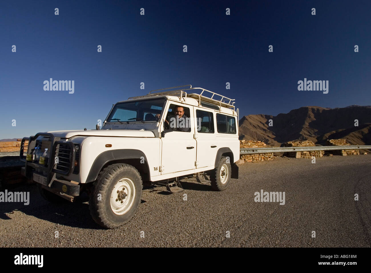 Land Rover Defender with driver High Atlas mountains Morocco Stock ...
