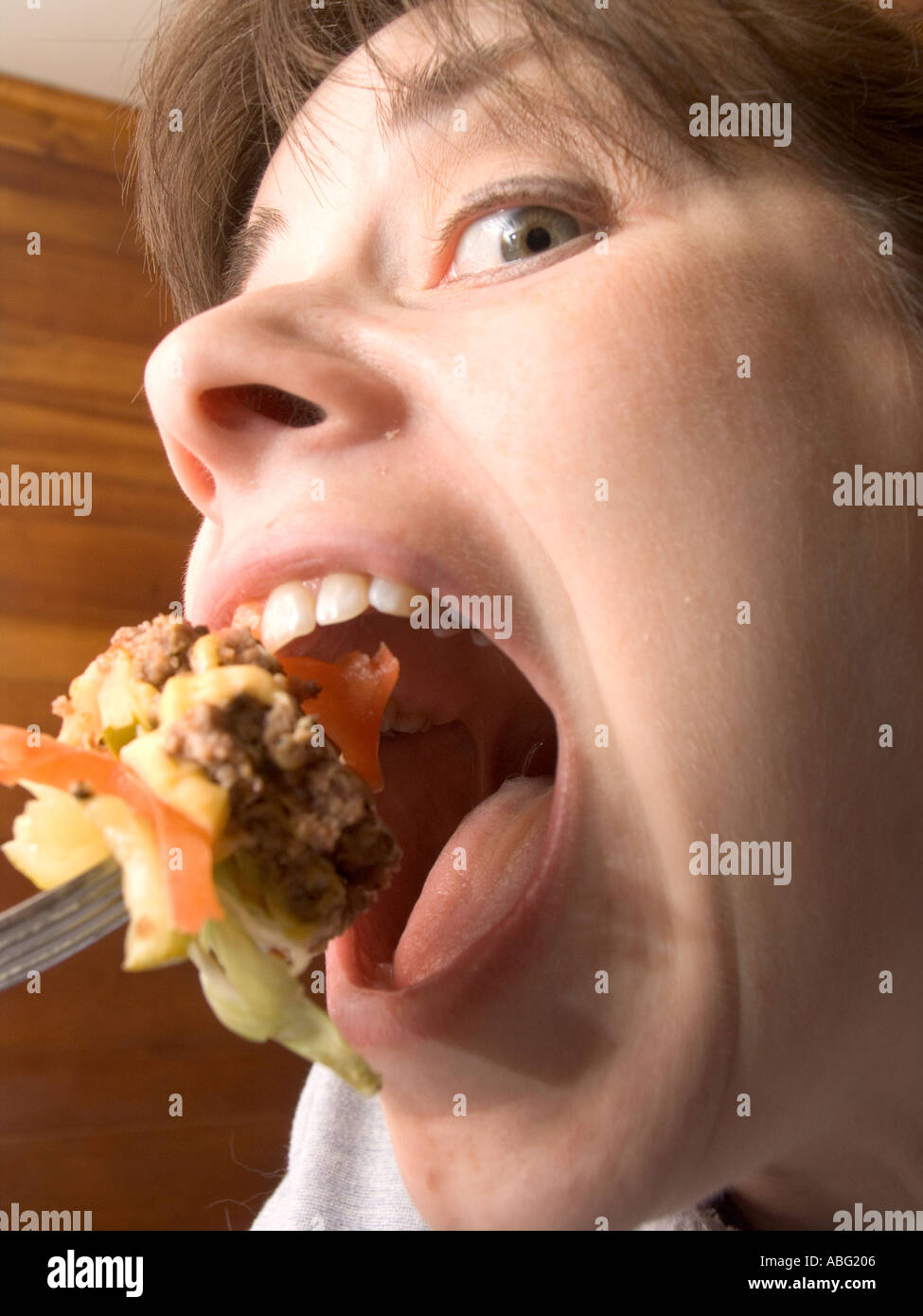 Woman alone eating hamburger hi-res stock photography and images - Alamy