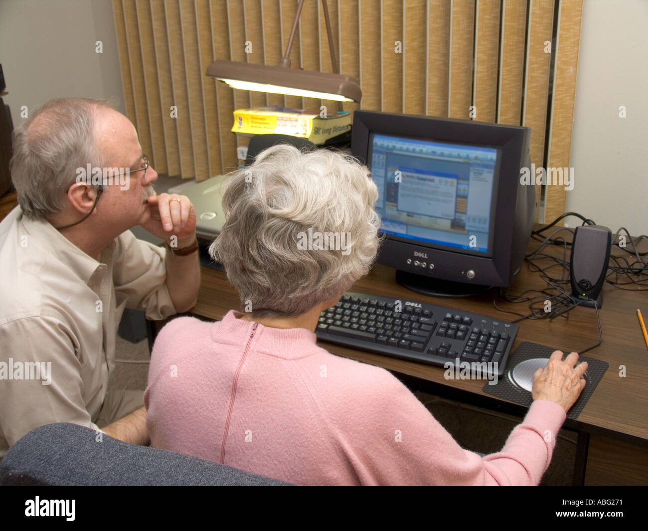 Middle aged son helping elderly mother with computer Stock Photo - Alamy