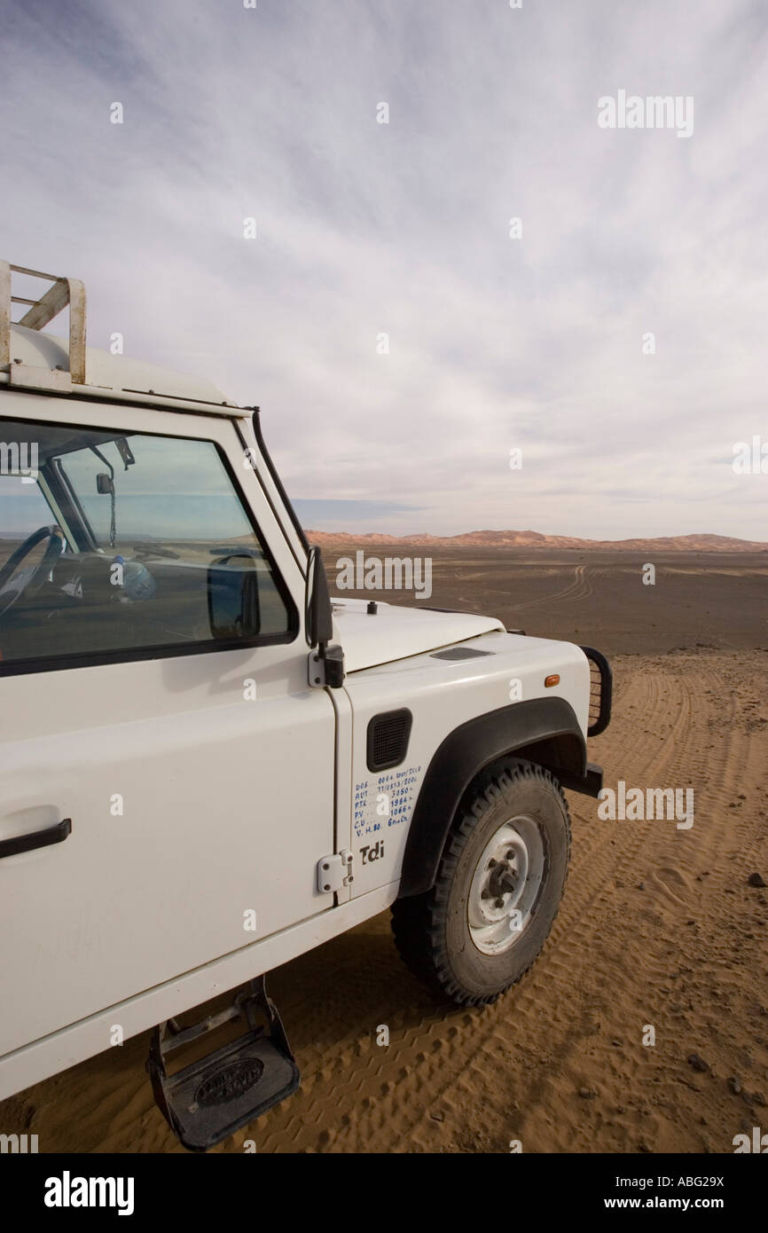 Land Rover Defender four wheel drive vehicle crossing on piste track ...