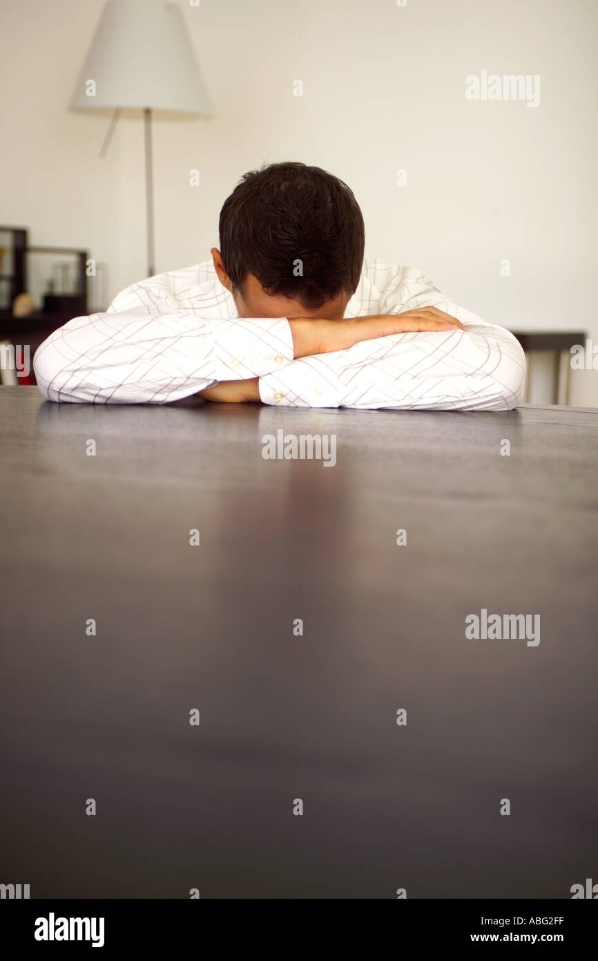businessman in office with his face lying on the table Stock Photo - Alamy