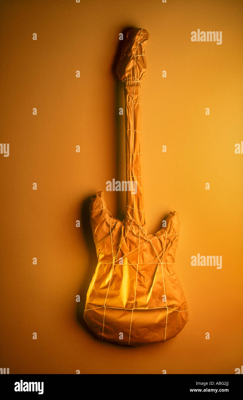 ELECTRIC GUITAR PRESENT WRAPPED IN BROWN WRAPPING PAPER.FENDER ...