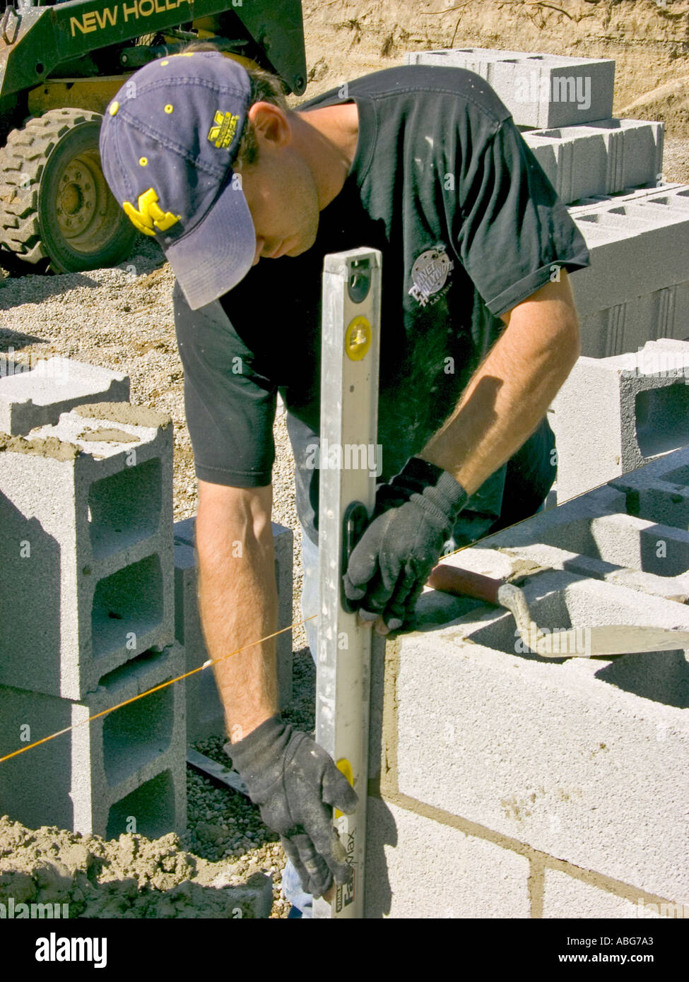 New home construction workers lay cement blocks to form basement of ...