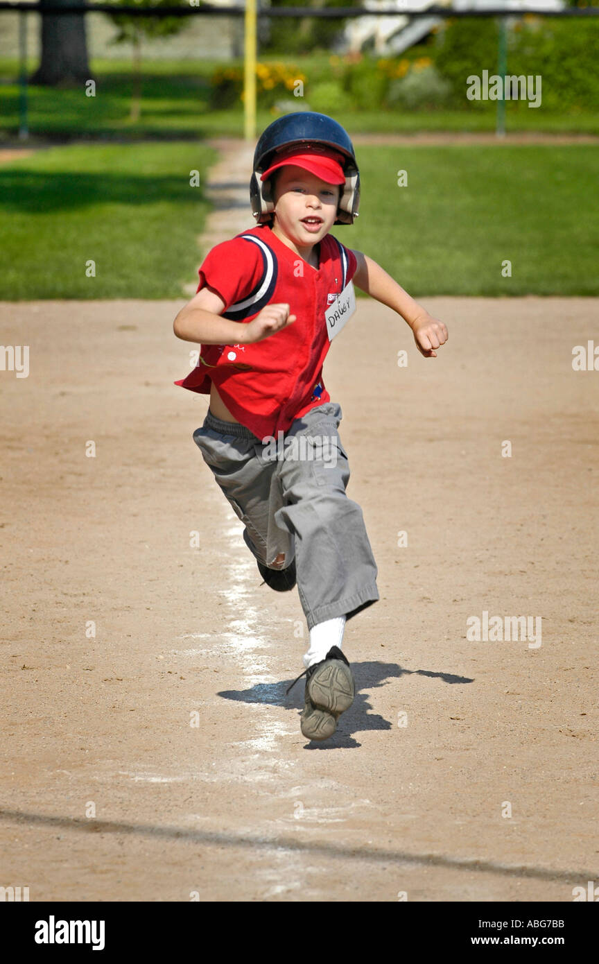 5 year old running girl learns to play baseball Stock Photo - Alamy