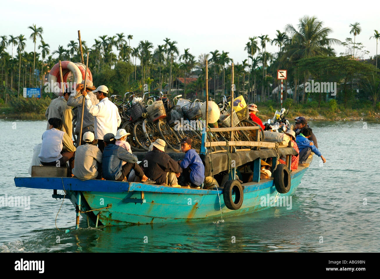 Overcrowded ferry boat crossing the Thu Bon River in Hoi An, Vietnam ...