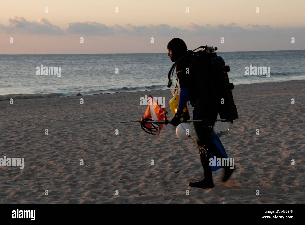 Diver walking toward the ocean Stock Photo - Alamy