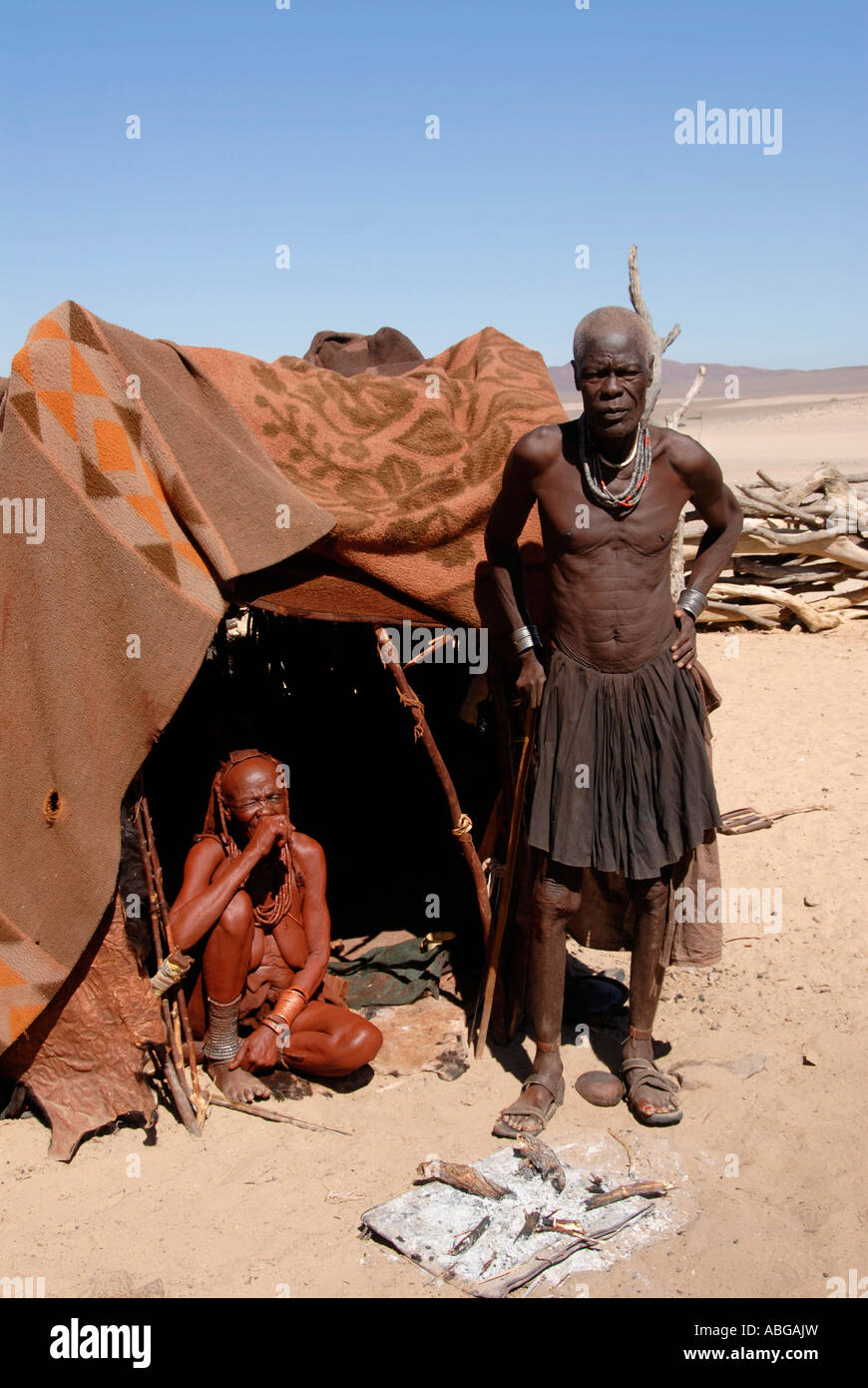Old Himba man and woman outside hut Kaokoveld Namibia Southern Africa ...