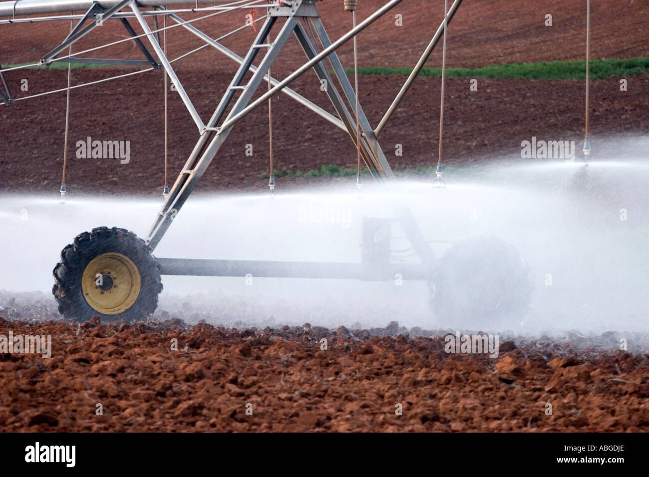 Farm Sprinkler wheeled plowed field Stock Photo - Alamy