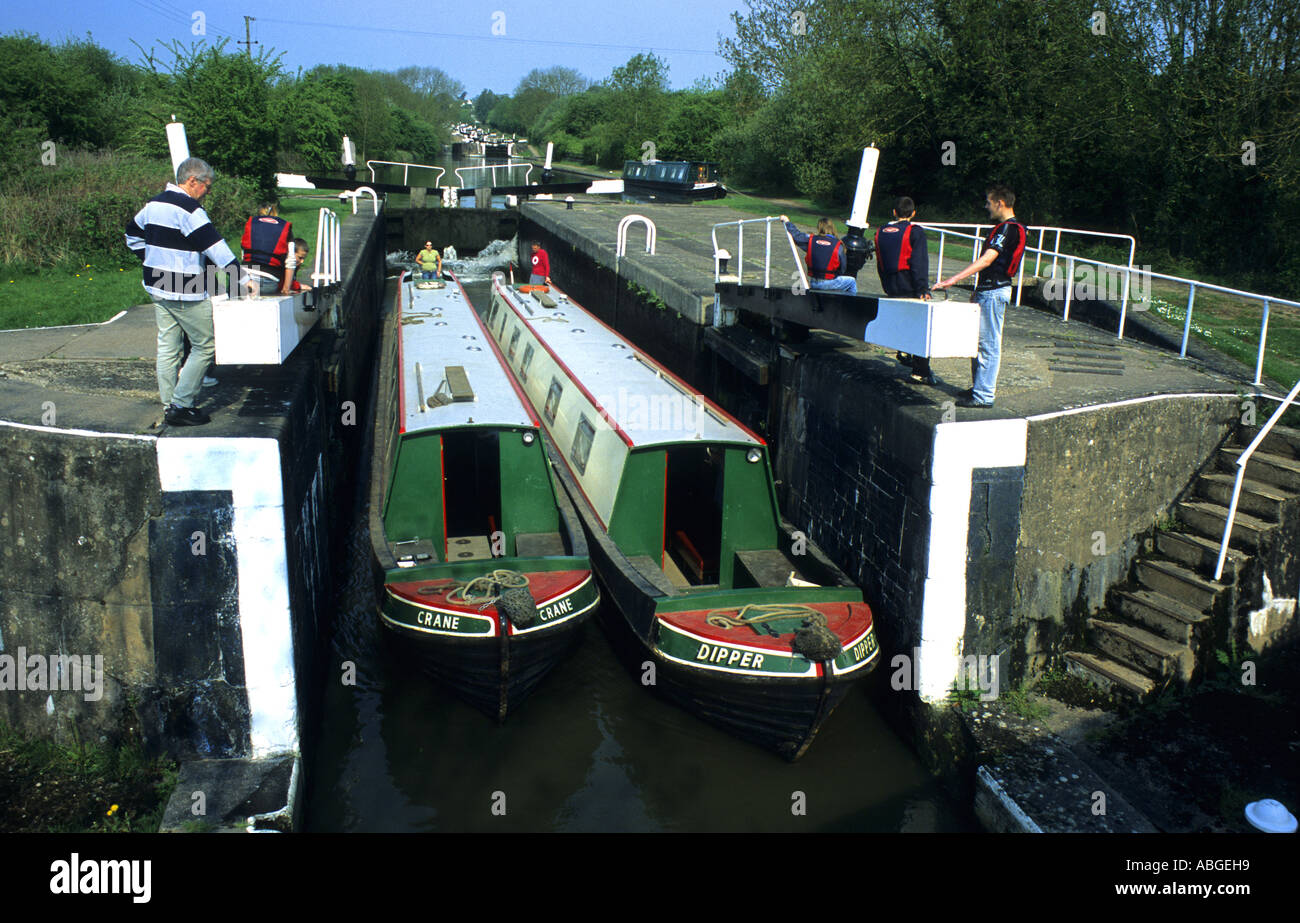 Pair of narrowboats leaving a lock at Hatton Locks, Grand Union Canal ...