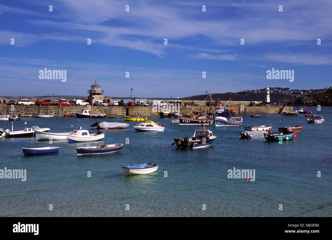 Boats floating in the clear water of St Ives harbour Cornwall England ...