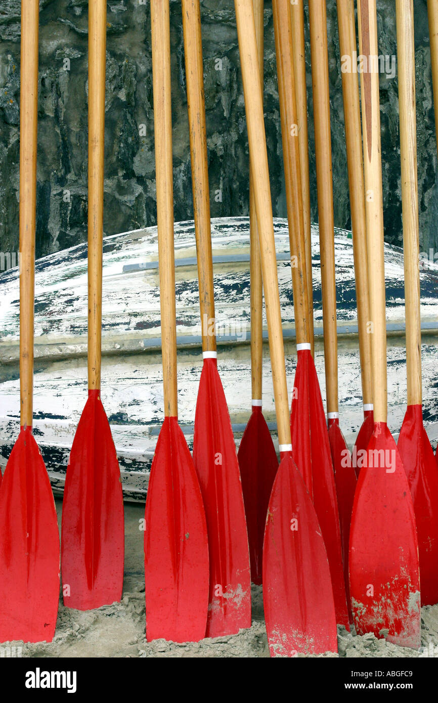 Pilot gig oars resting against the harbour wall at Newquay Cornwall UK ...