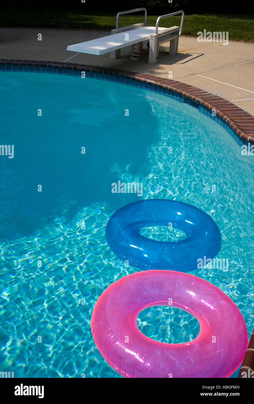 Diving board and inflatable rings in a pool Stock Photo - Alamy