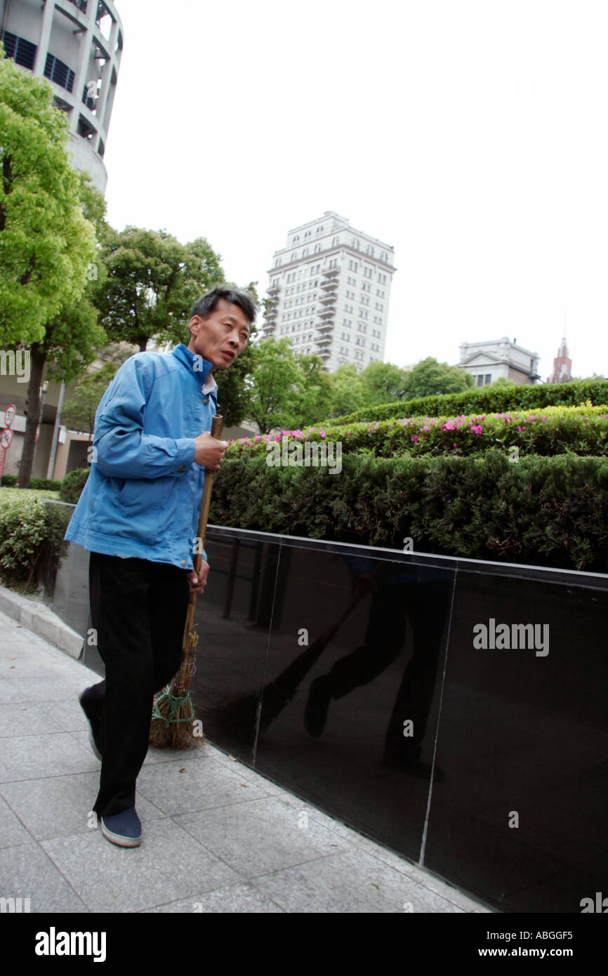 Man sweeps the street hi-res stock photography and images - Alamy