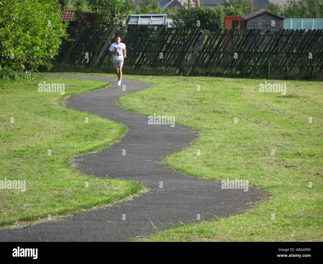 "male running alone along a snake shaped path Stock Photo - Alamy