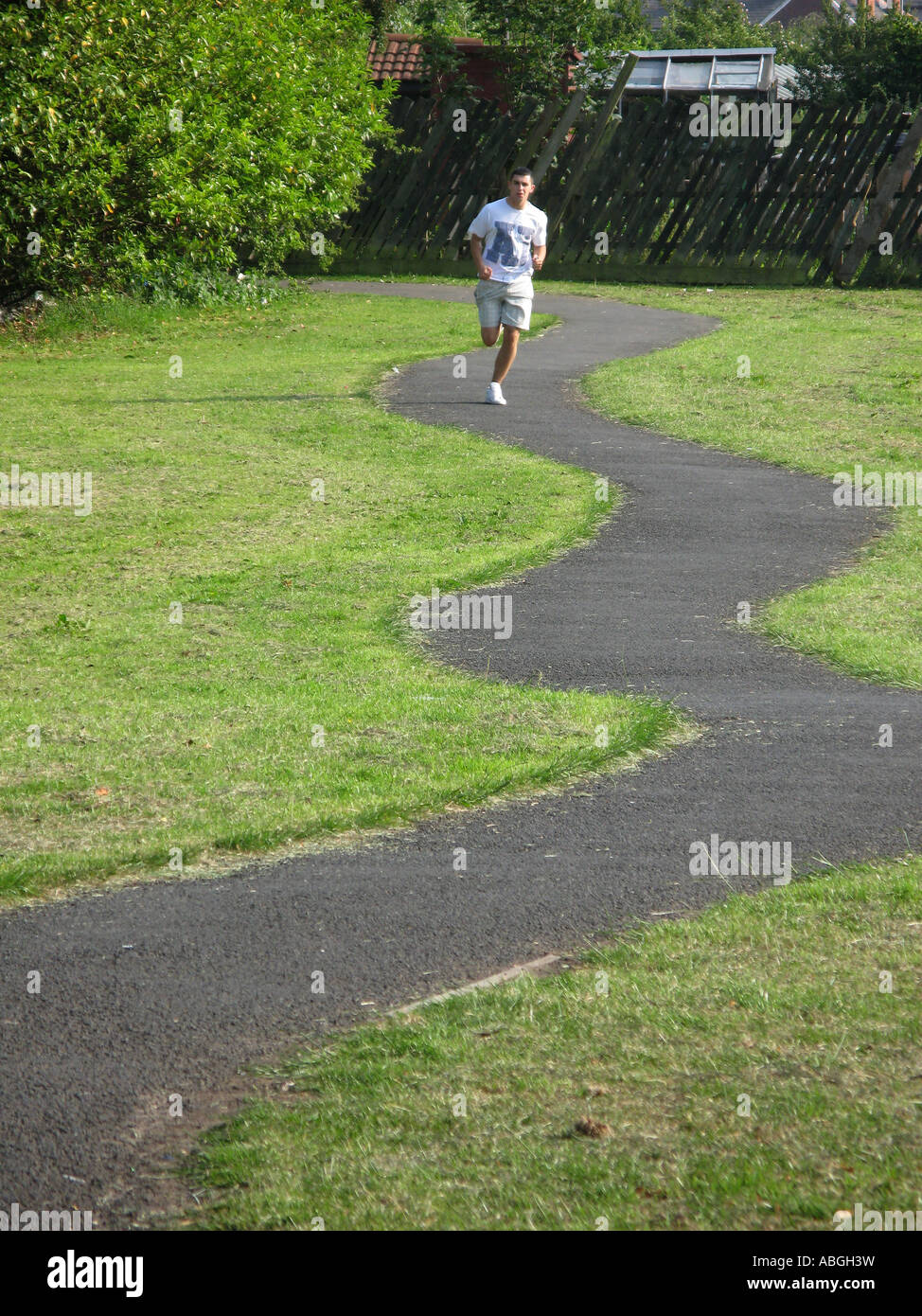 "male running alone along a snake shaped path Stock Photo - Alamy