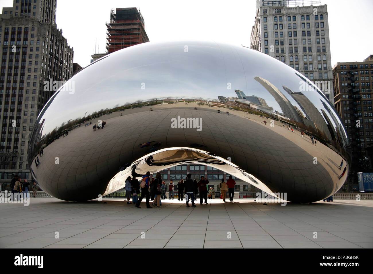 People standing underneath the Cloud Gate Sculpture in Millennium Park ...