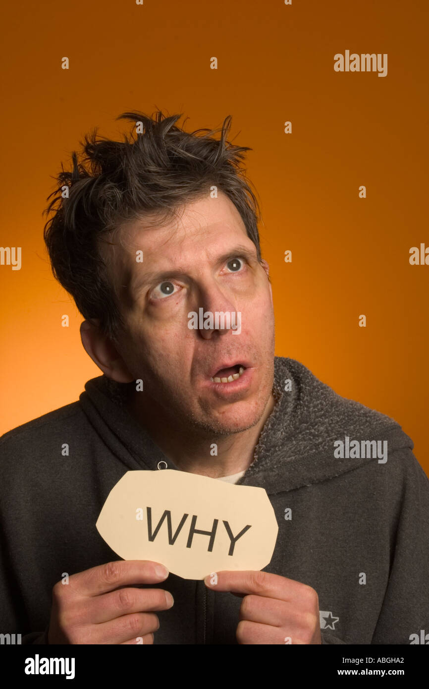 Scary looking man holding a sign reading "Why Stock Photo - Alamy